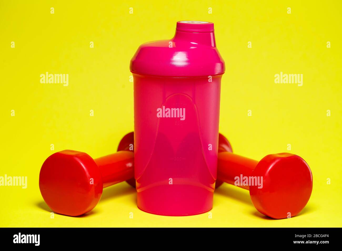 red dumbbells, pink shaker, colored background, sports, energy drink ...