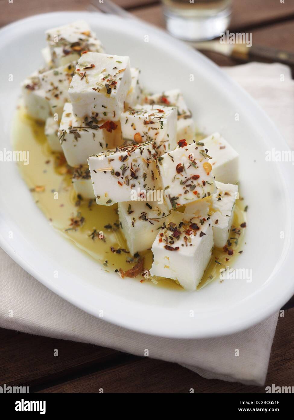 Greek feta cheese cut into cubes and seasoned with olive oil and ...