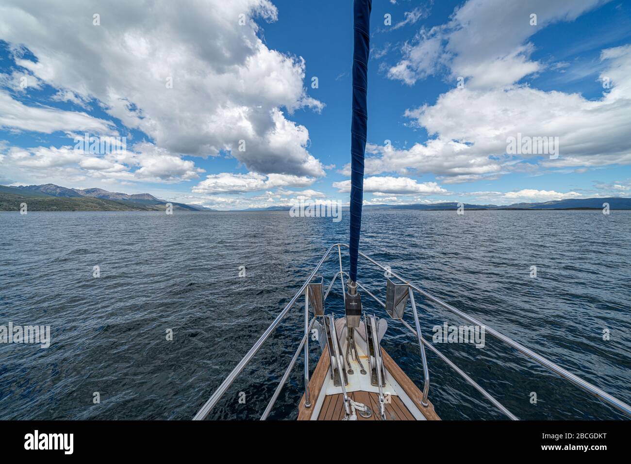 sailing boat in Antarctica, yacht navigation through icebergs and sea ...