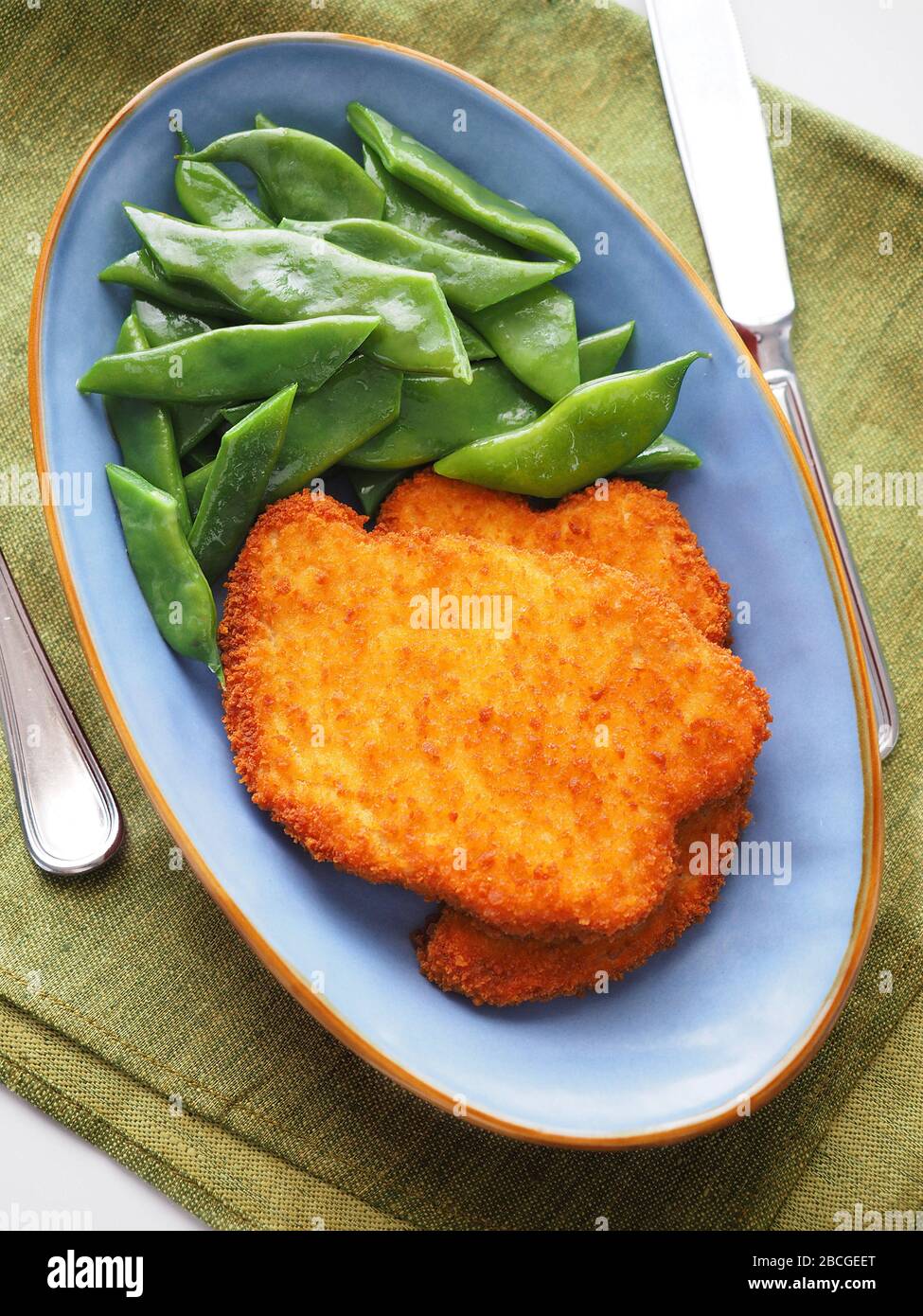 Swordfish breaded cutlet with snow peas stir-fried, Italy, Europe Stock ...