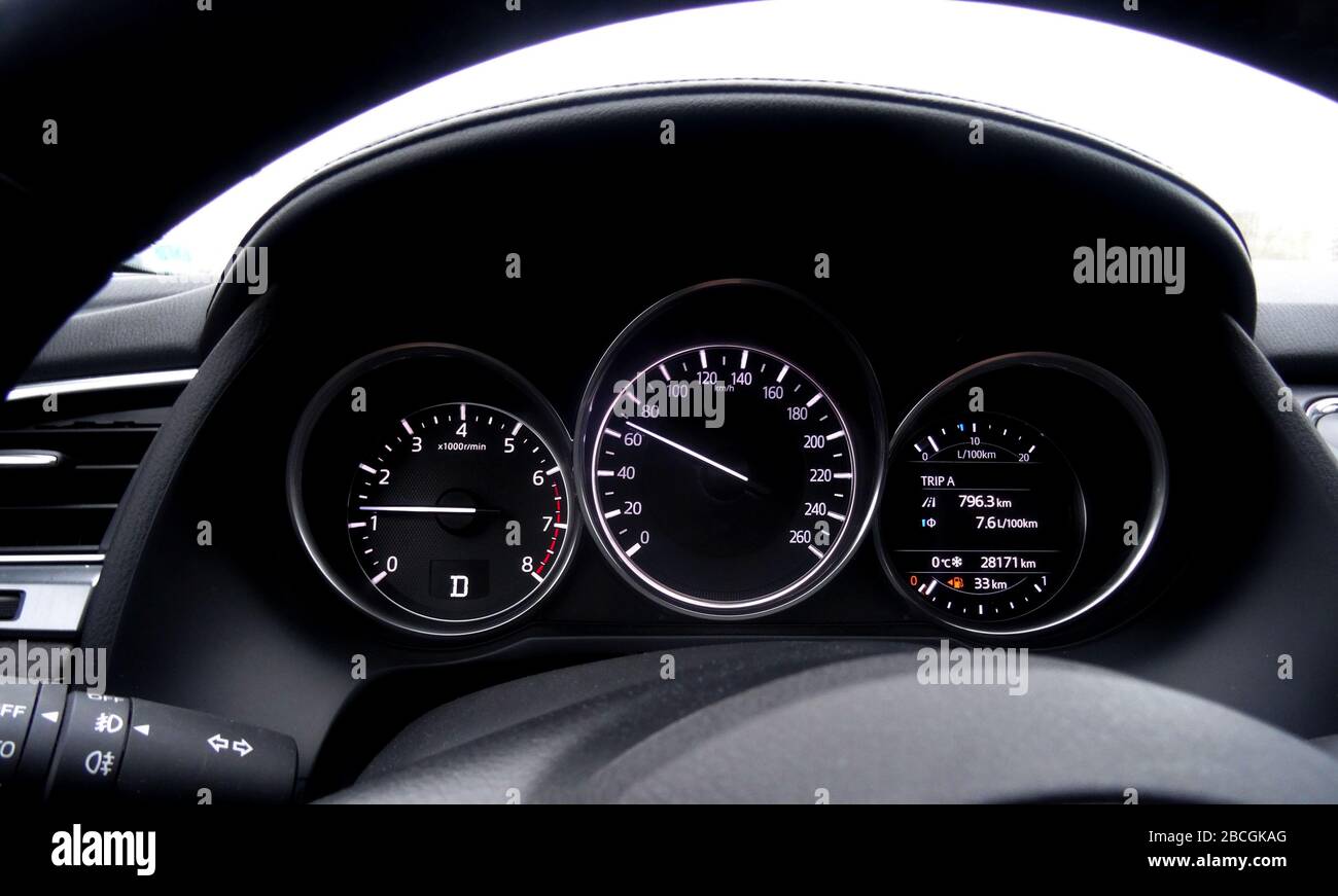 Glowing dashboard showing engine revolutions and speed inside a car ...