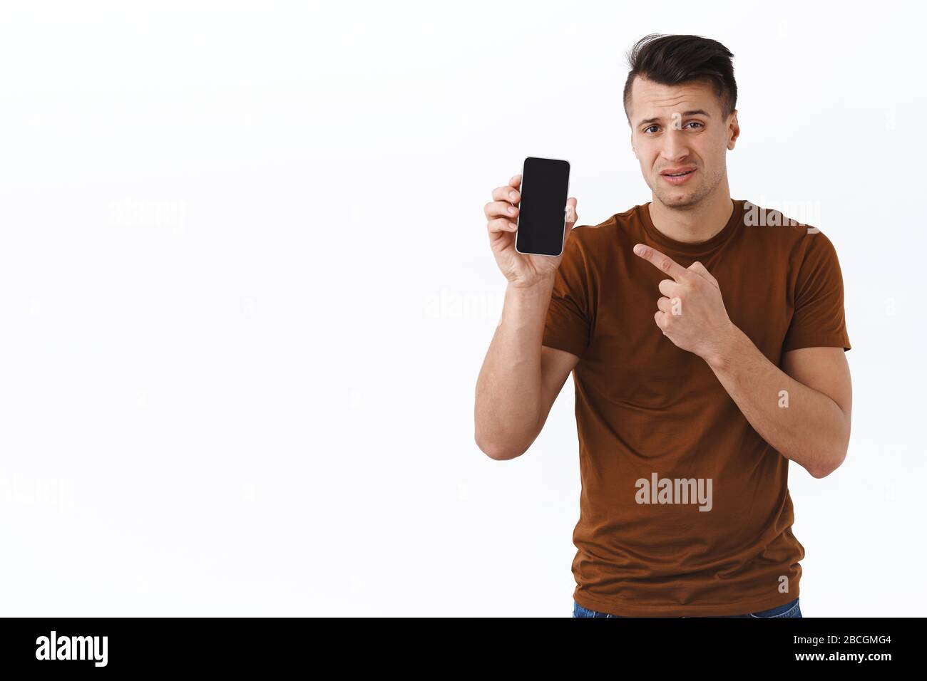 Skeptical and unimpressed caucasian italian guy in brown t-shirt ...