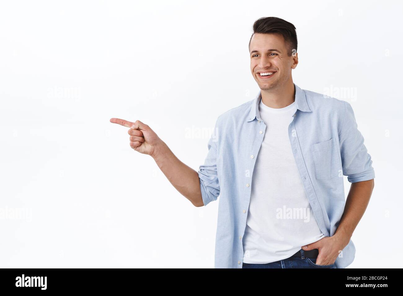 Portrait of handsome adult man pointing finger left and smiling happy ...