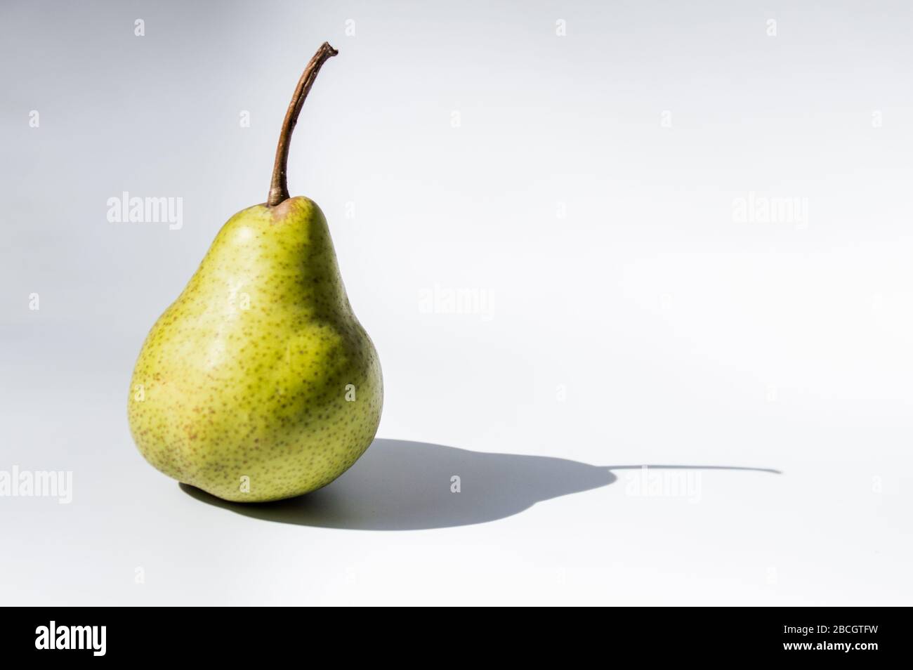 Pear fruit with a shadow Stock Photo - Alamy