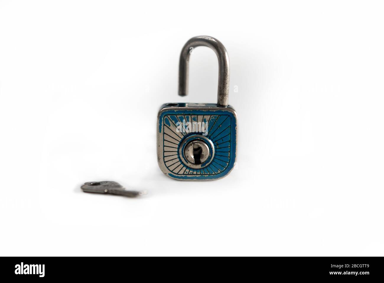 An open old padlock with a key, white background Stock Photo - Alamy