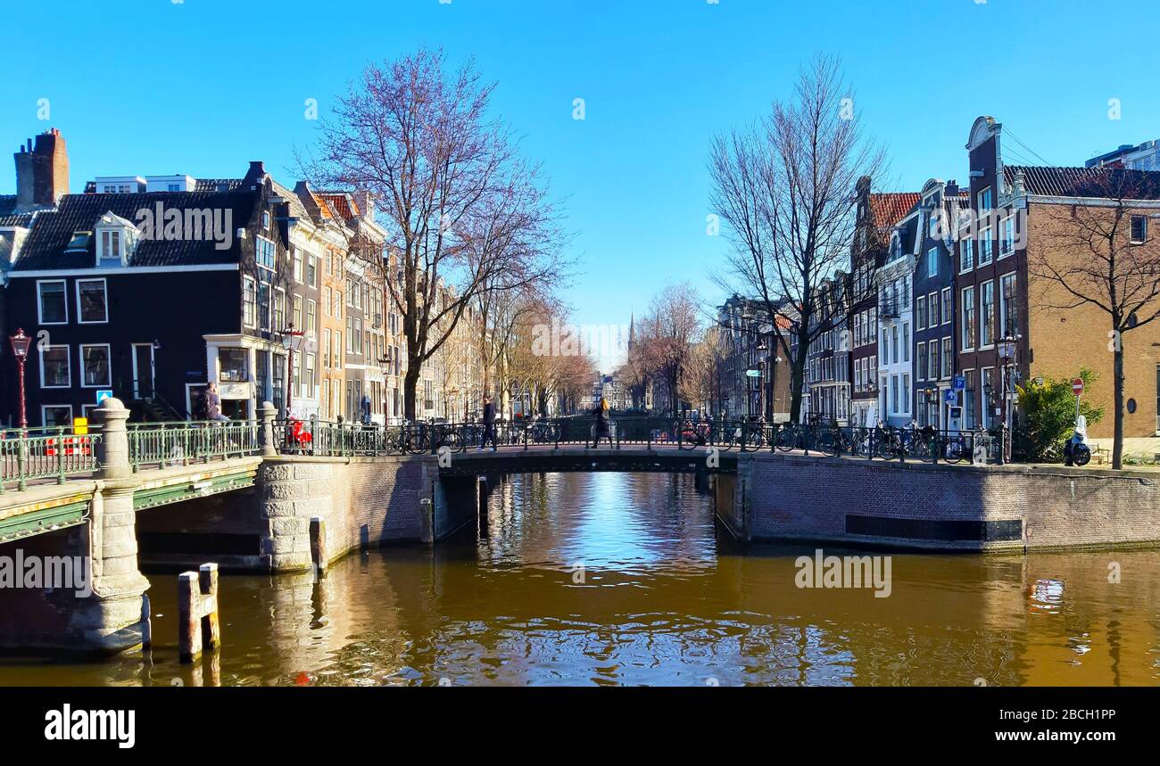 normal daily life in the canal waters of amsterdam between buildings in ...
