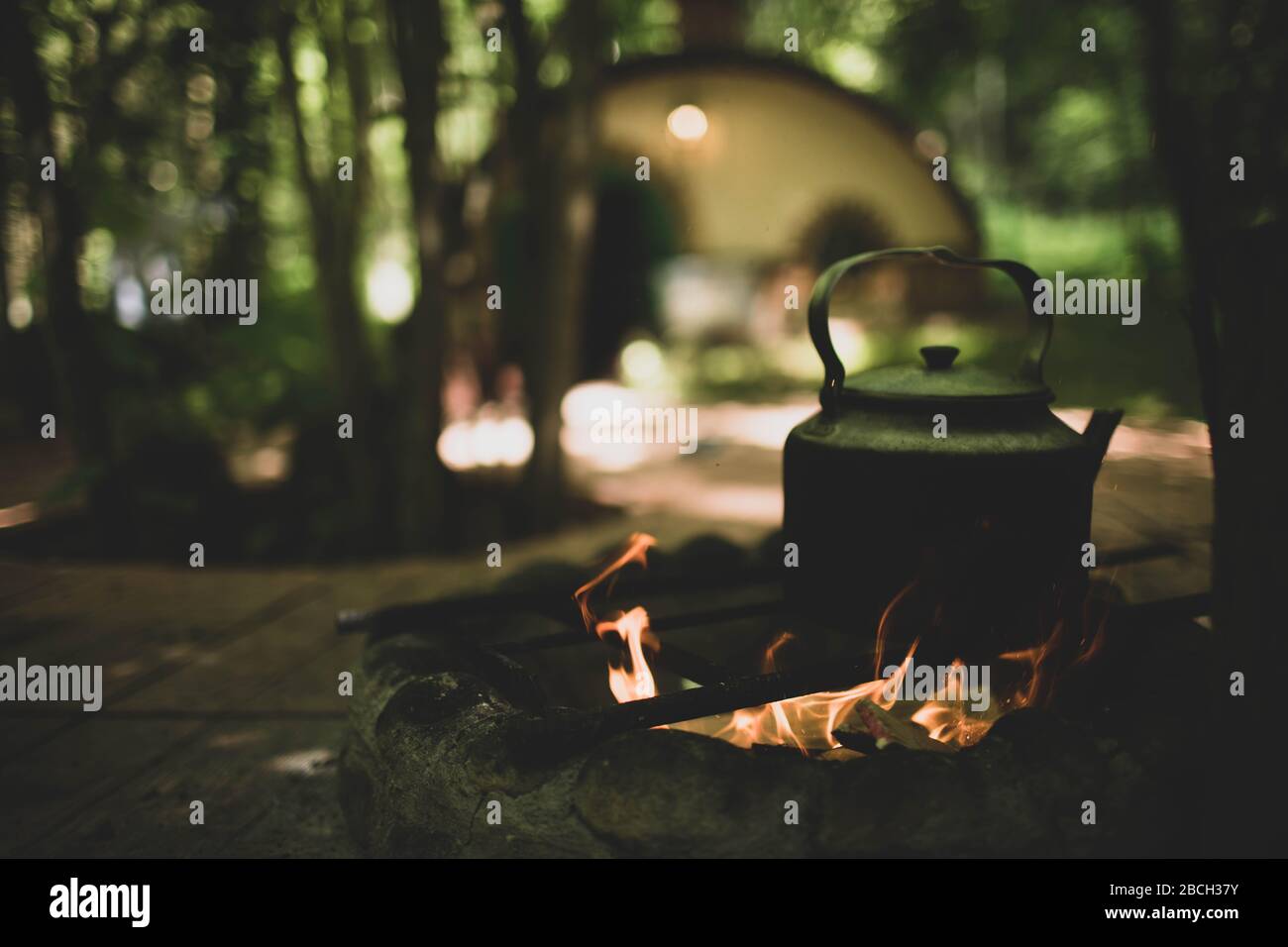 Metal teapot to boil on fire in the summer in the country. Close up ...