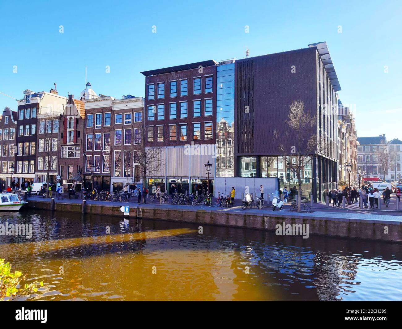 normal daily life in the canal waters of amsterdam between buildings in ...