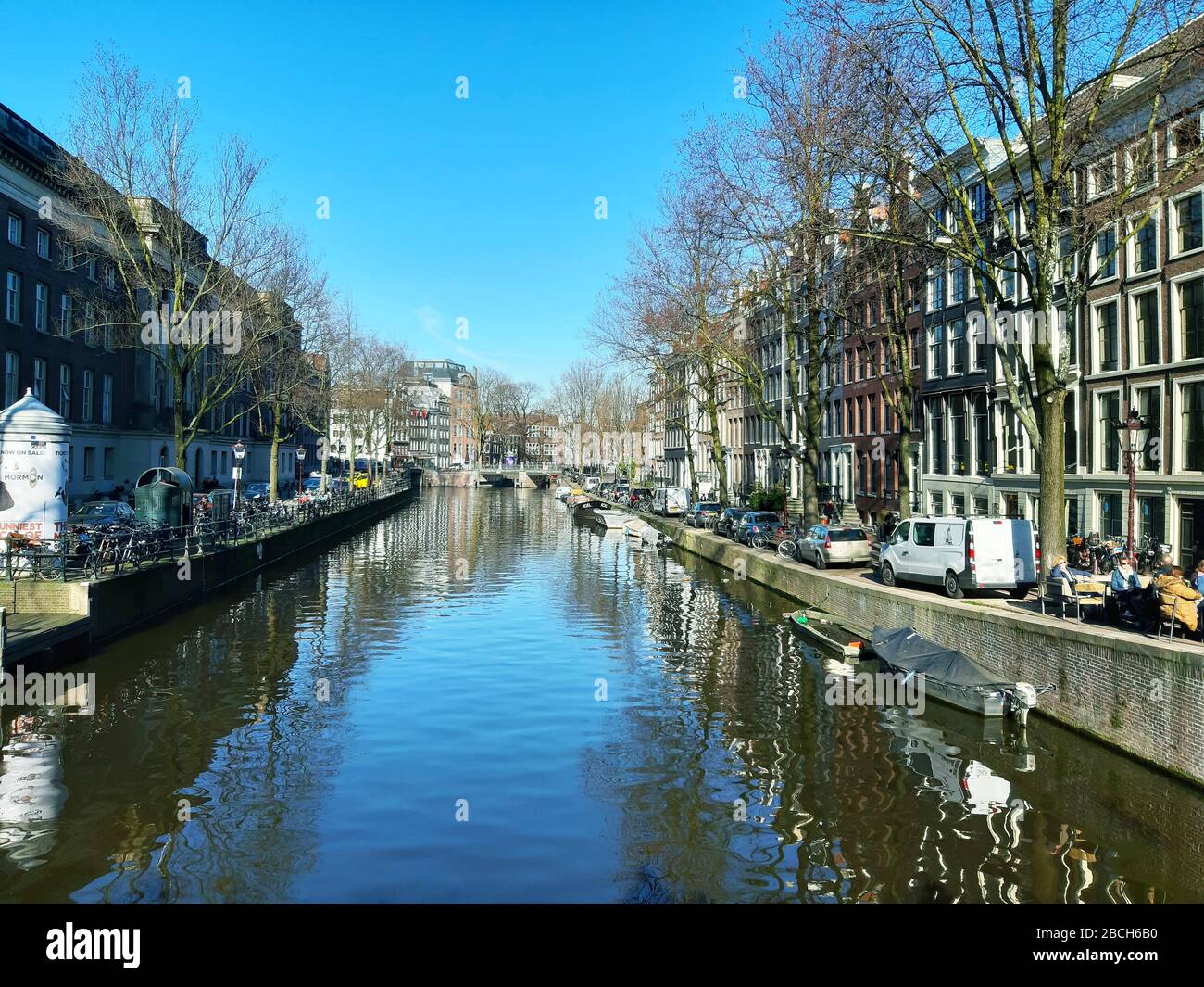 normal daily life in the canal waters of amsterdam between buildings in ...