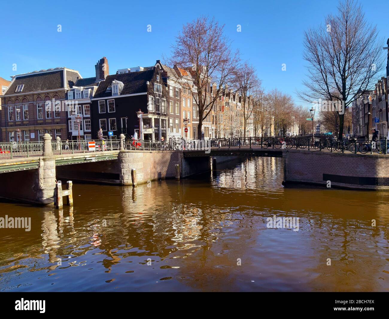 normal daily life in the canal waters of amsterdam between buildings in ...