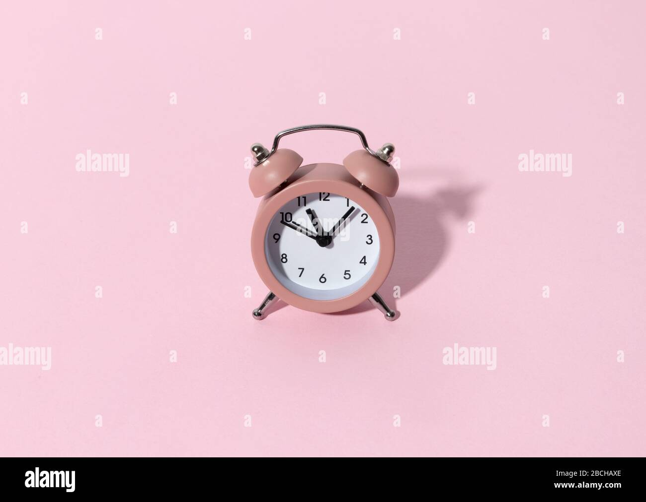 Pink alarm clock on pastel color paper background with copy space Stock ...