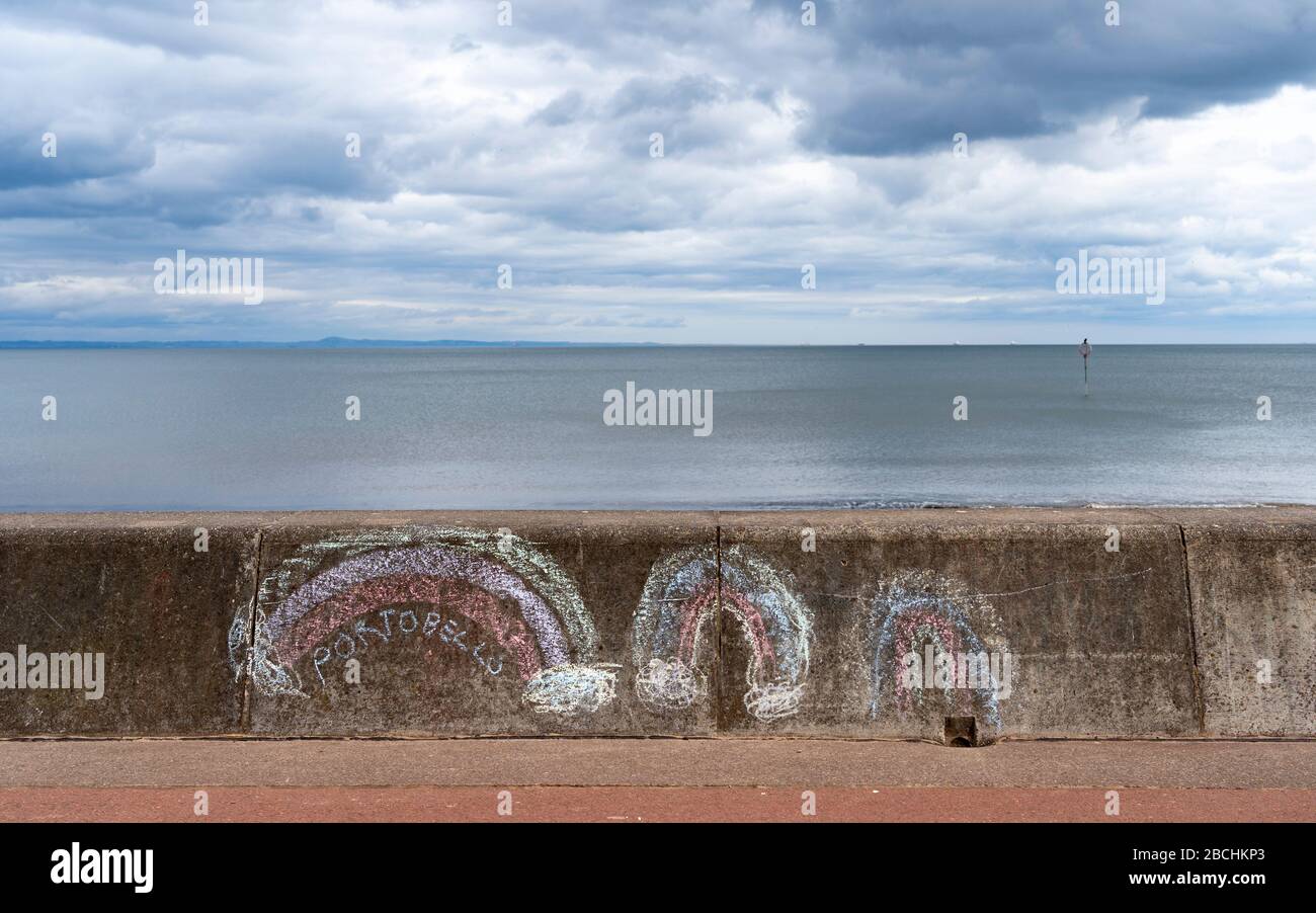 View of chalk drawings with rainbows on Portobello promenade during ...