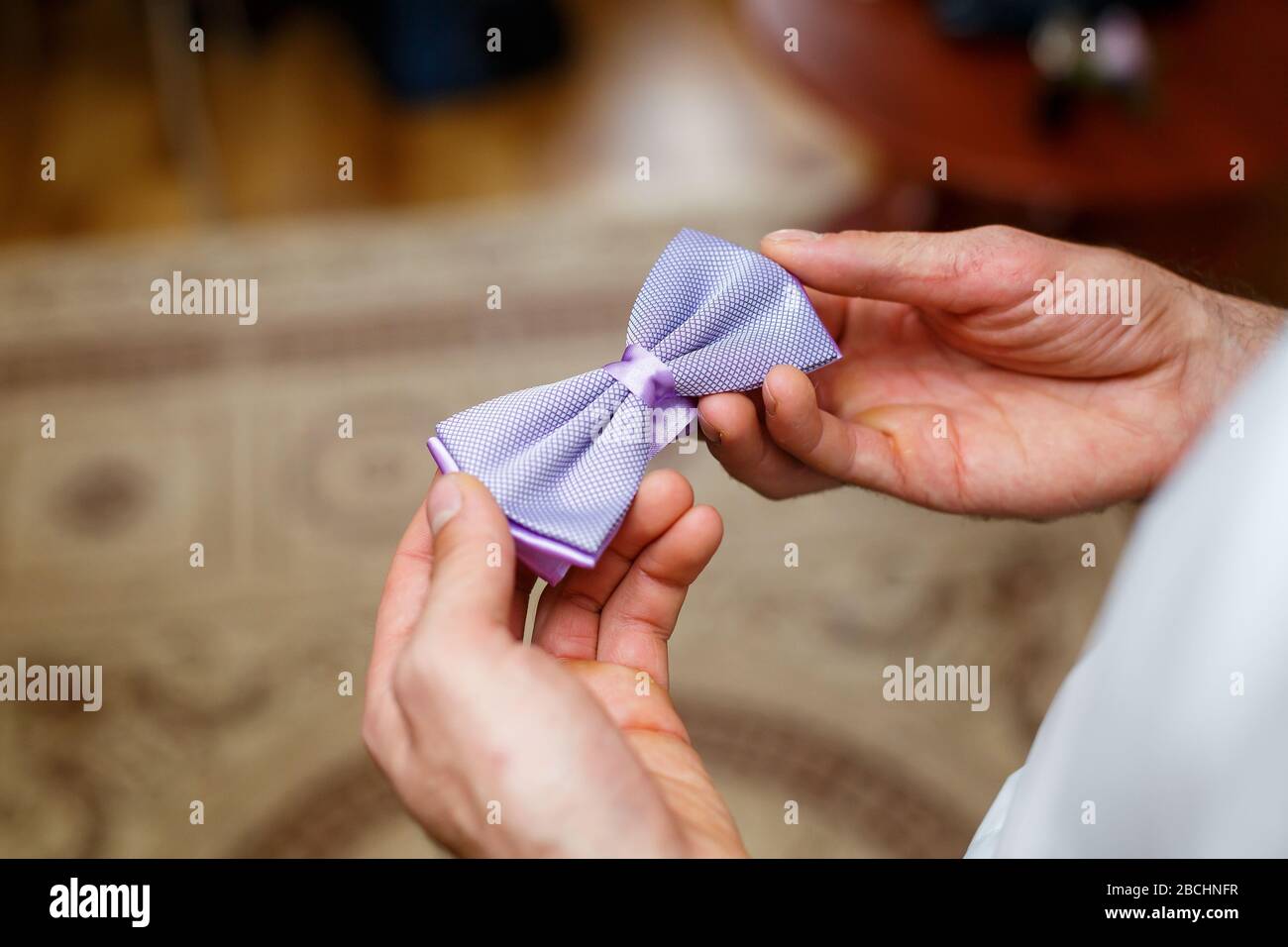 Male hands correct wedding bowtie hi-res stock photography and images ...