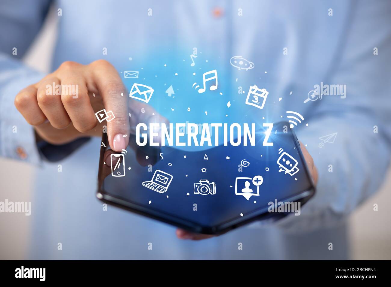 Businessman holding a foldable smartphone with GENERATION Z inscription ...