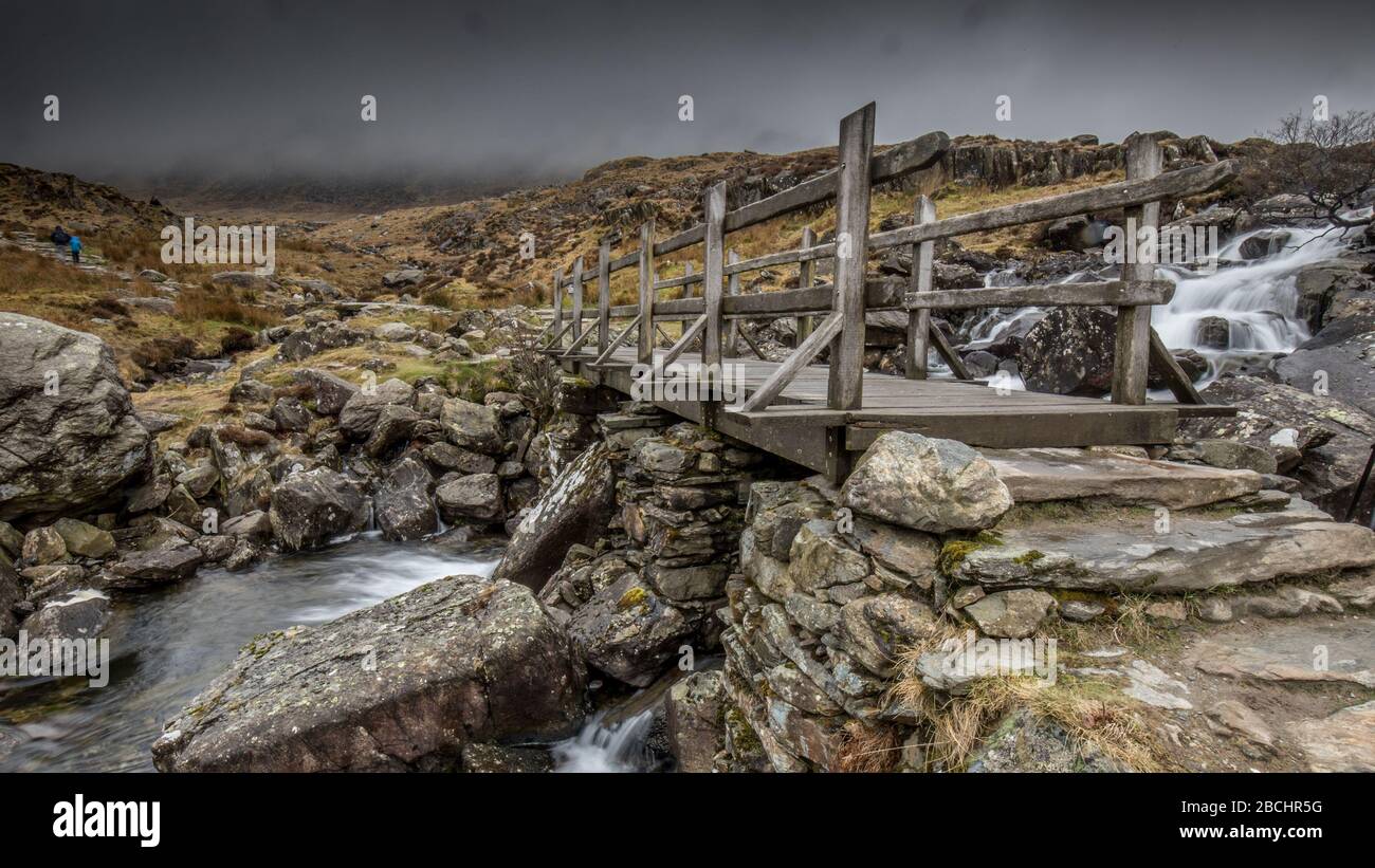 Wooden footbridge and footpath in Snowdonia on the way to Cwm Idwal ...