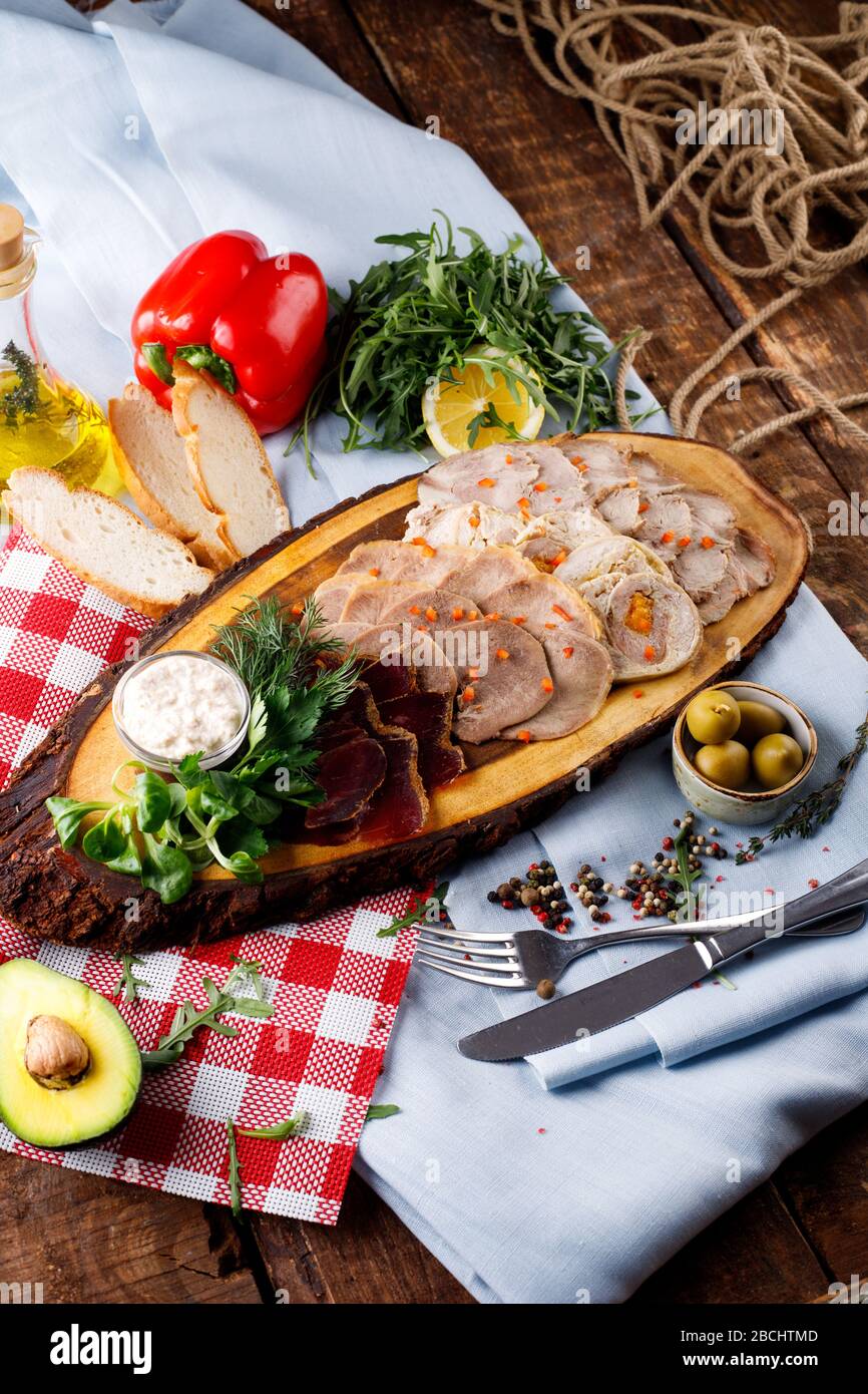 cold cuts - different types of meat, on the background of a wooden ...