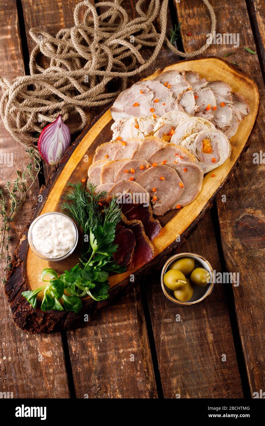 cold cuts - different types of meat, on the background of a wooden ...