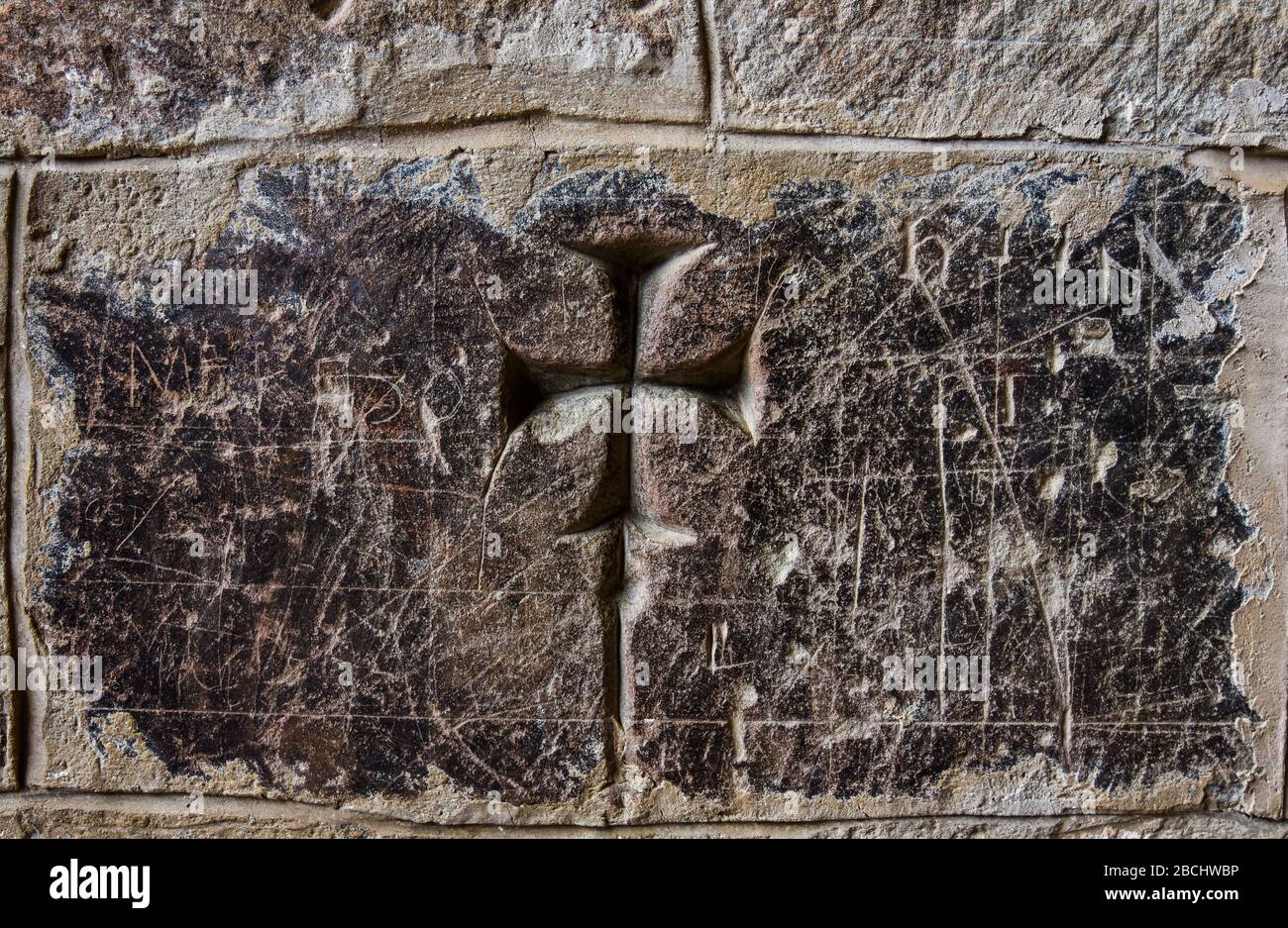 a medieval cross carved in the stone of an old monastery in Jaca Stock ...