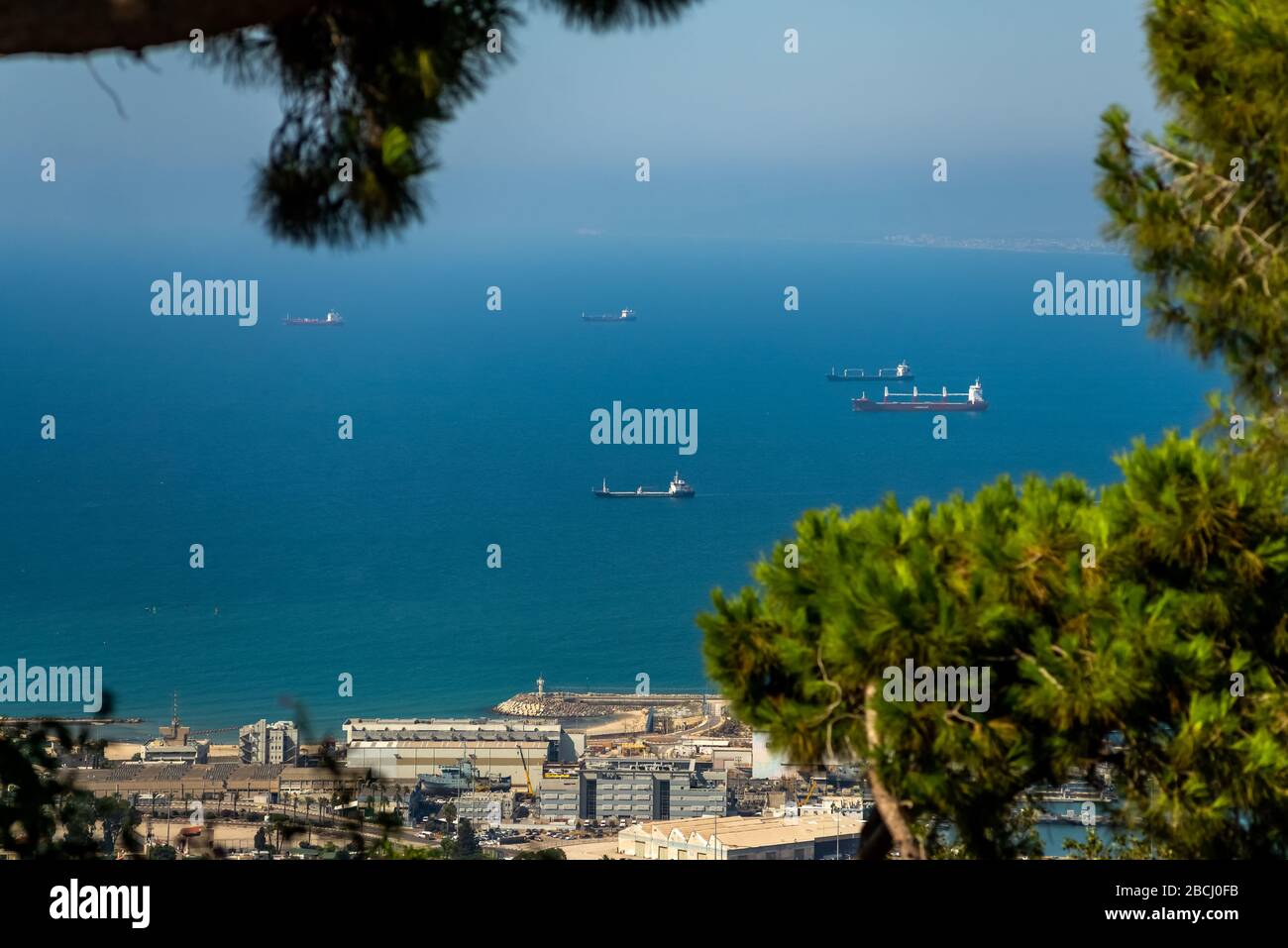 Landscape with lots of cargo ships in the sea.Ships are in the raid or ...