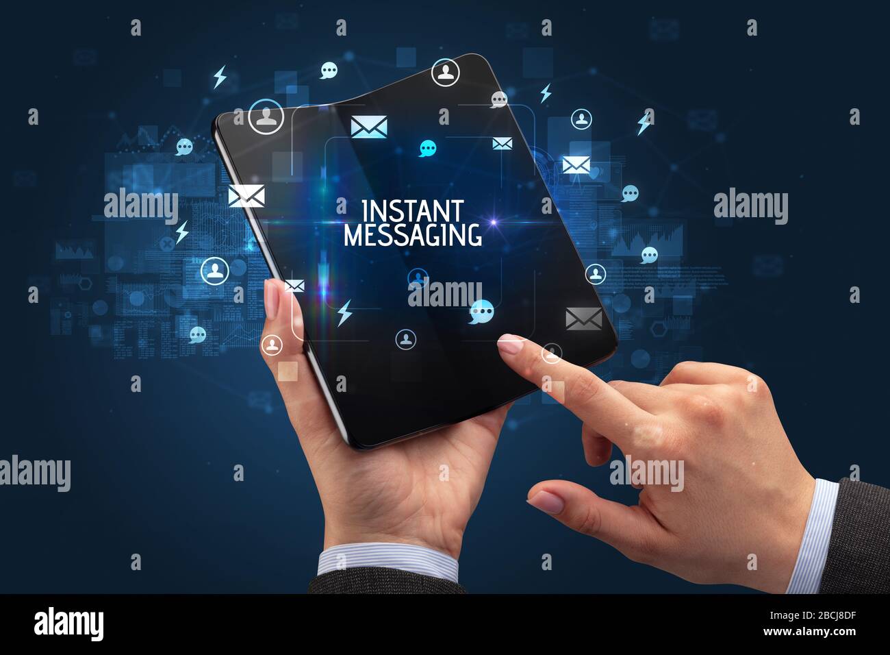 Businessman holding a foldable smartphone with INSTANT MESSAGING ...