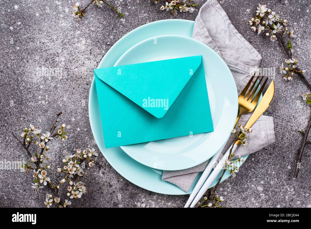 Spring table setting with envelope Stock Photo - Alamy