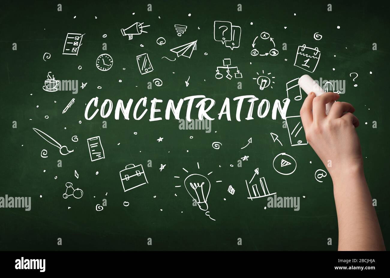 Hand drawing CONCENTRATION inscription with white chalk on blackboard ...
