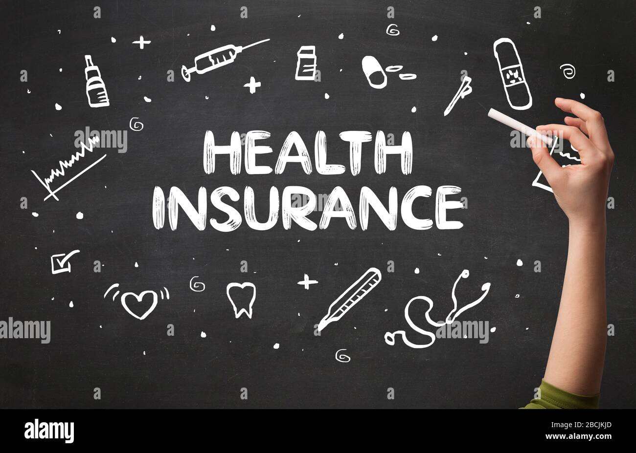 Hand drawing HEALTH INSURANCE inscription with white chalk on ...
