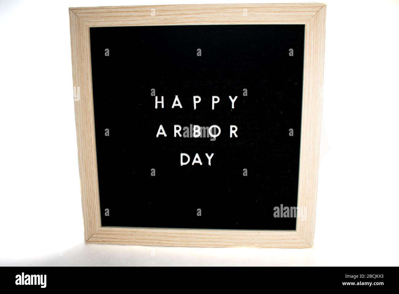 A Black Sign With White Letters That Says Happy Arbor Day on a White ...