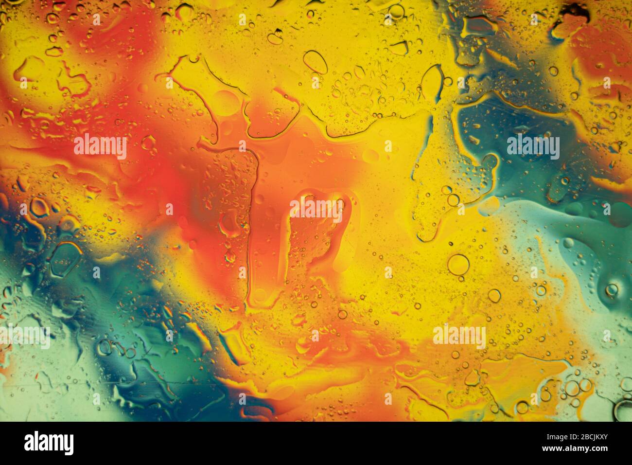 Oil and water mixed together creates an abstract colourful picture ...