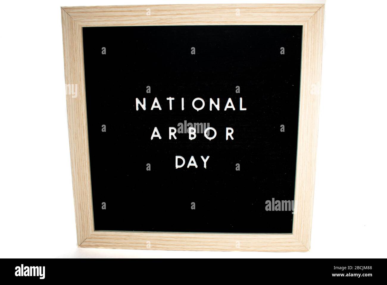 A Black Sign With White Letters That Says National Arbor Day on a White ...