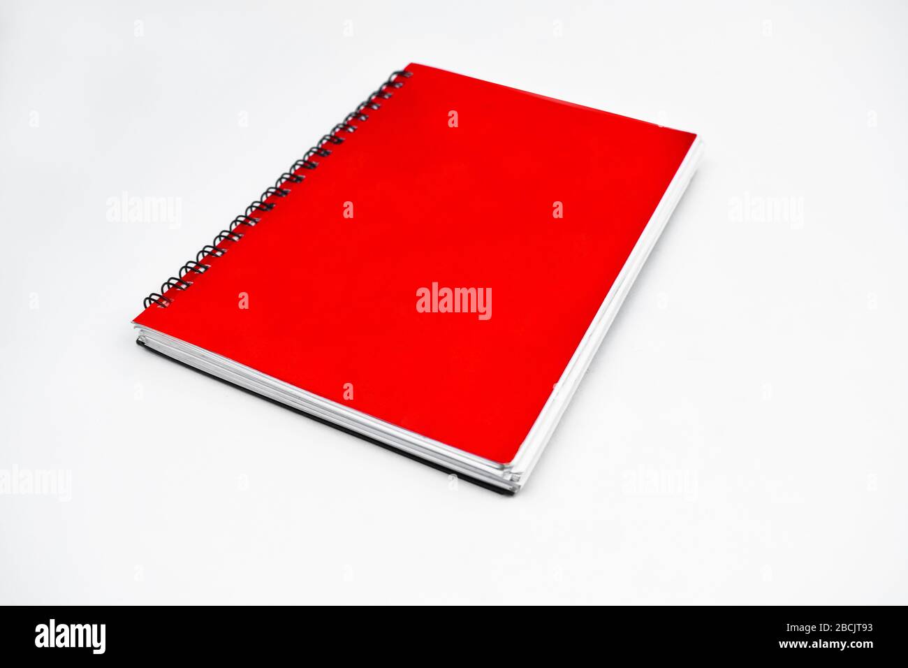 Side view of a red color covered single note paper diary isolated on an ...