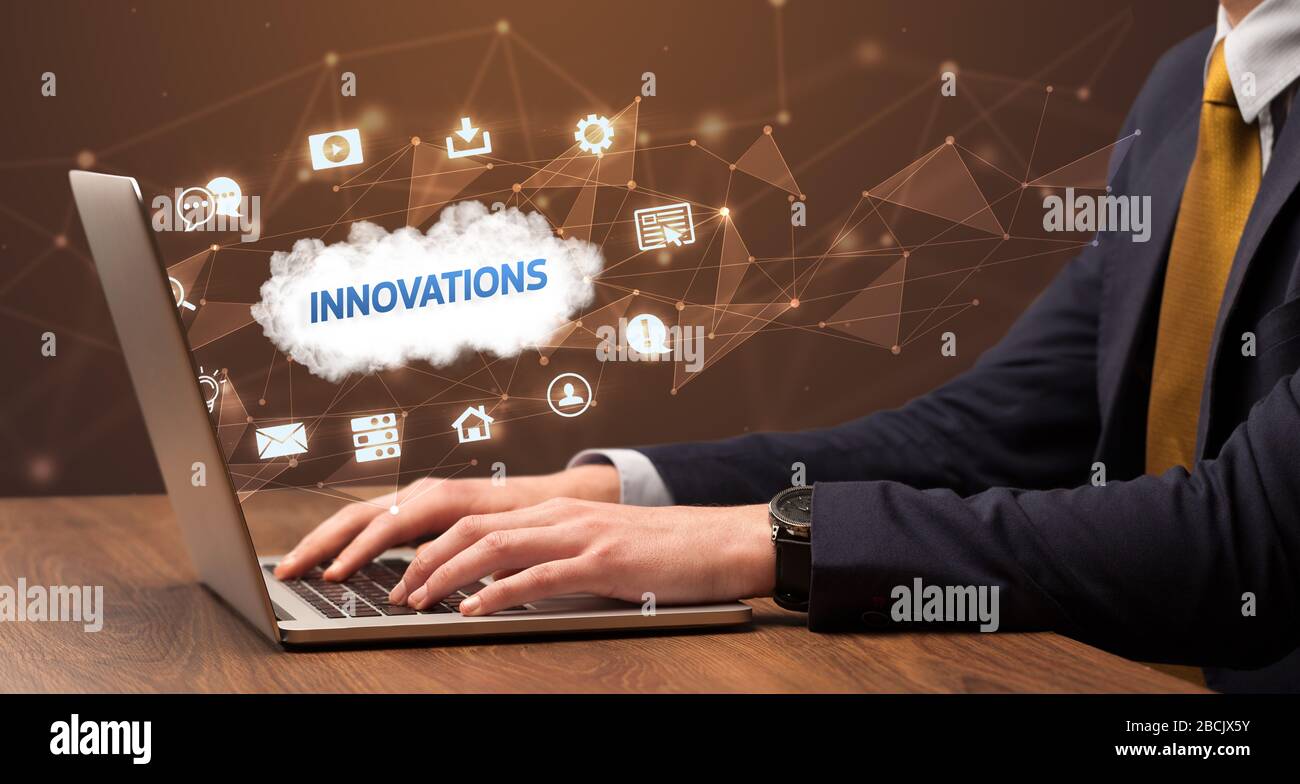 Businessman working on laptop with INNOVATIONS inscription, modern ...