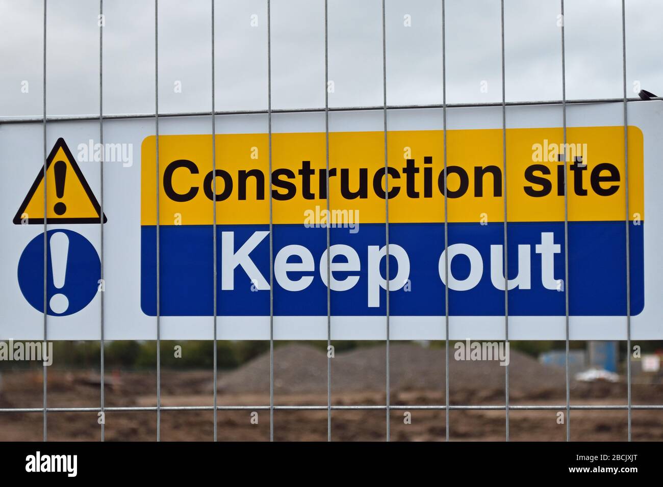 Construction site keep out sign on metal fence with blurred ...