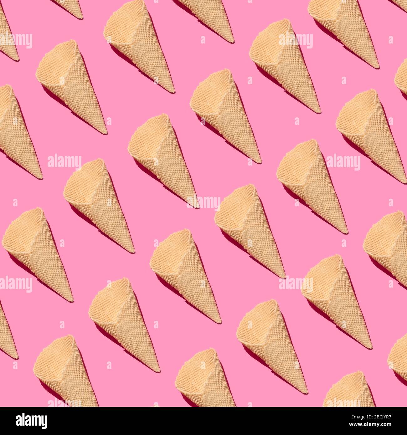 Waffle cone pattern on pink background Stock Photo - Alamy