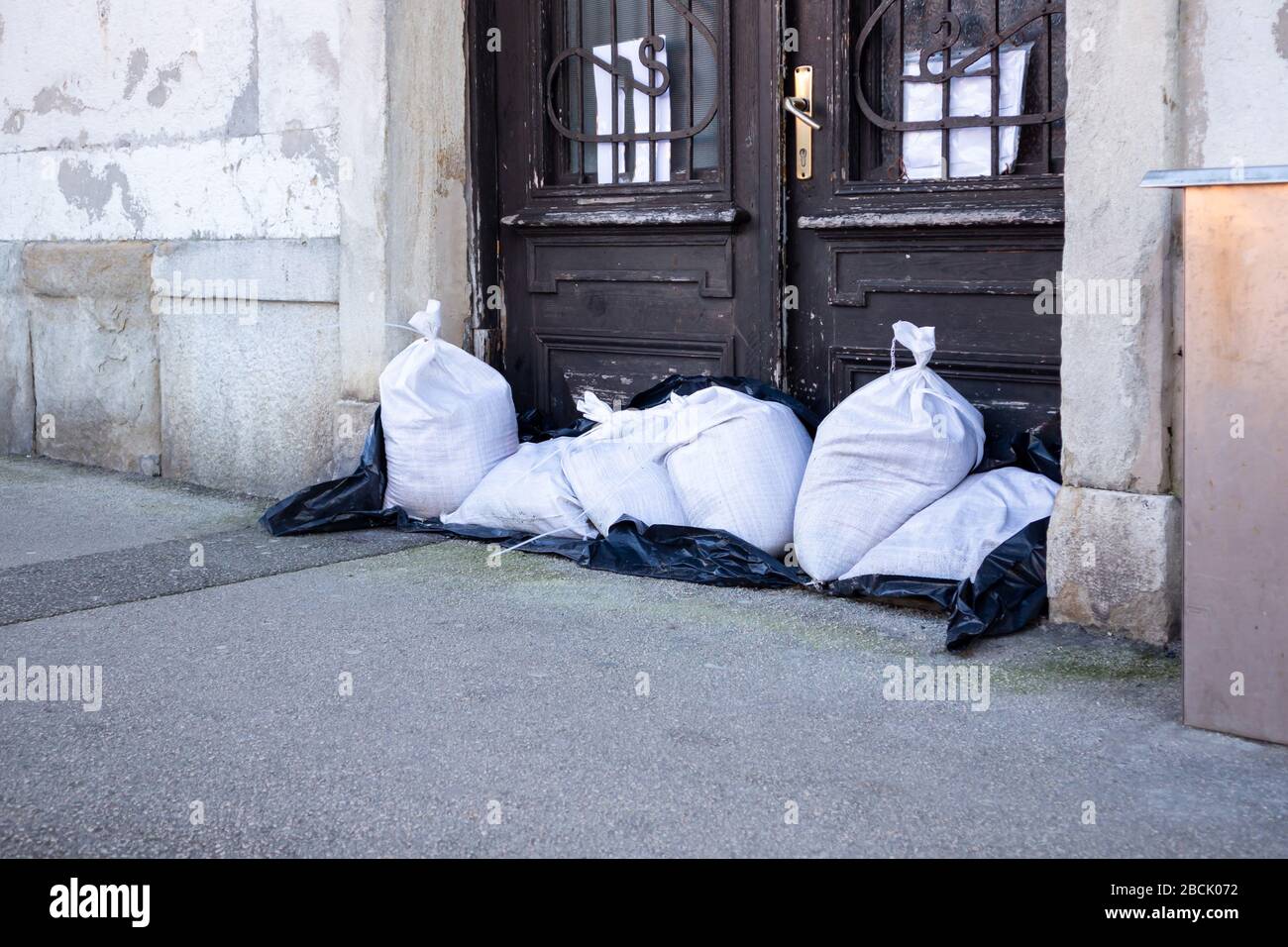 Sandbags stacked in front of doors to protect against flooding of river ...
