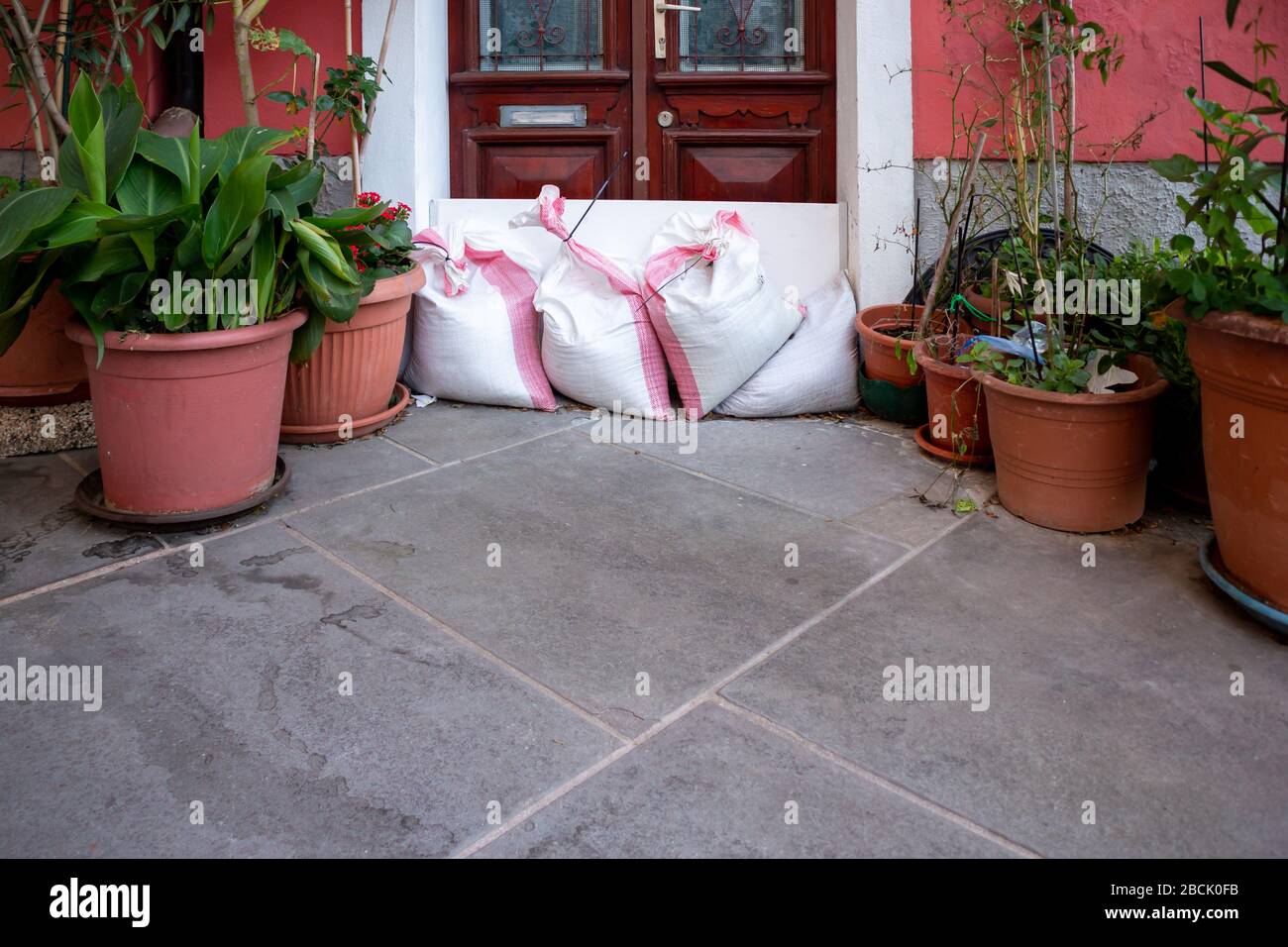 Sandbags stacked in front of doors to protect against flooding of river ...
