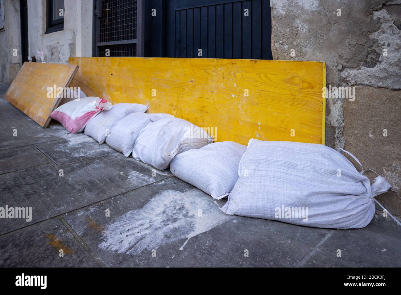 Sandbags stacked in front of doors to protect against flooding of river ...