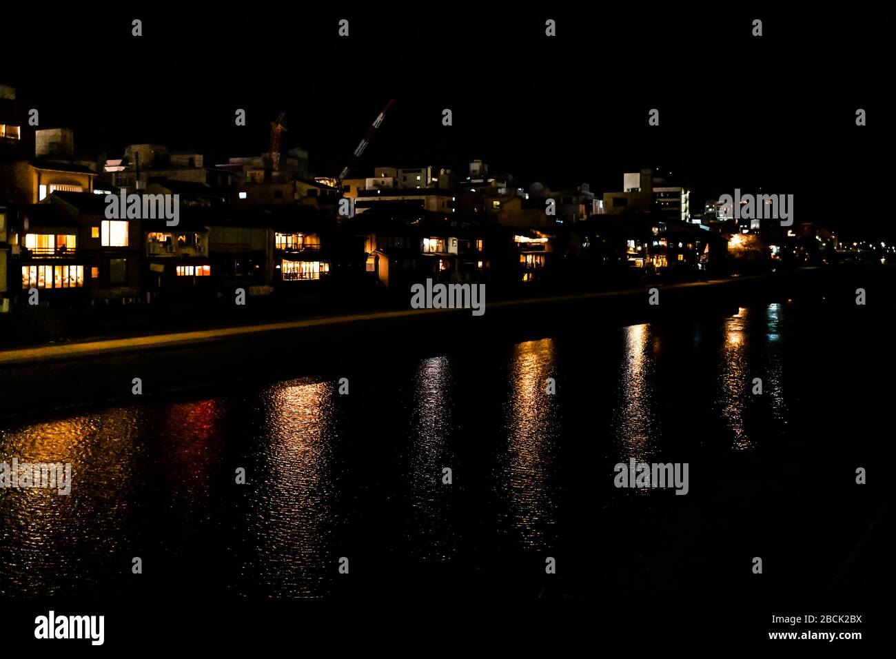 Kyoto, Japan illuminated waterfront houses reflection along Kamo river ...