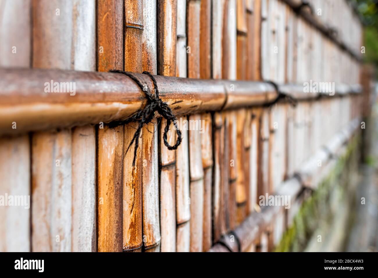 Kyoto, Japan residential area with closeup of bamboo wooden fence with ...