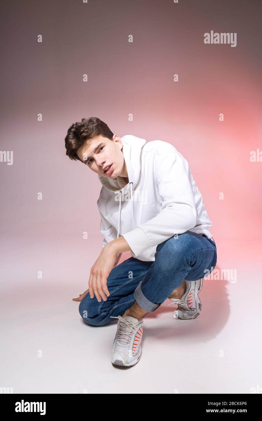 Fashionable handsome young European male model dressed in white ...