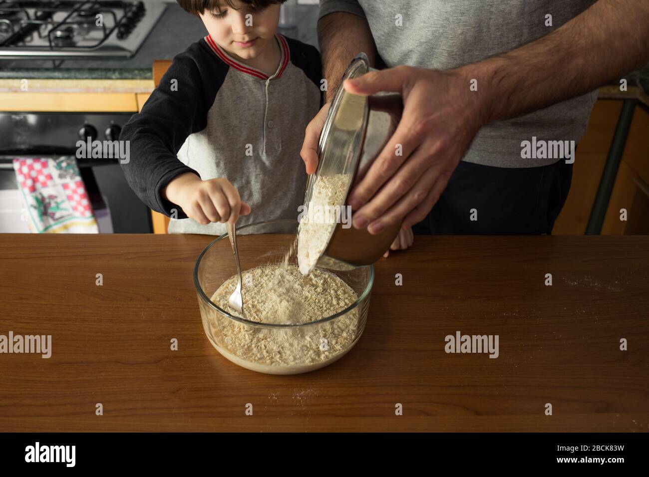 authentic image of a child making bread with his father Stock Photo - Alamy