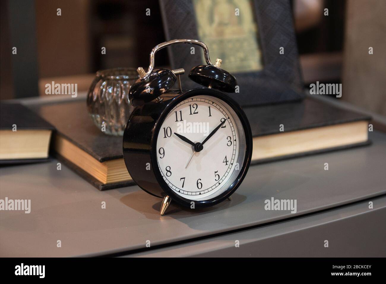 Alarm clock on the table in the bedroom. Interiors Stock Photo - Alamy