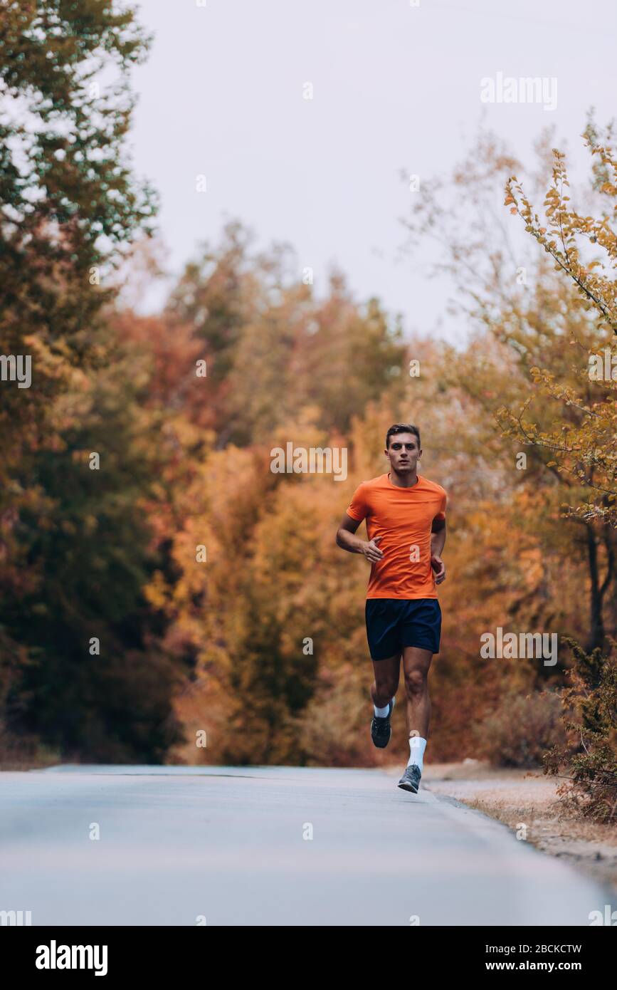 Runner Man running with concentration, determination and strength ...