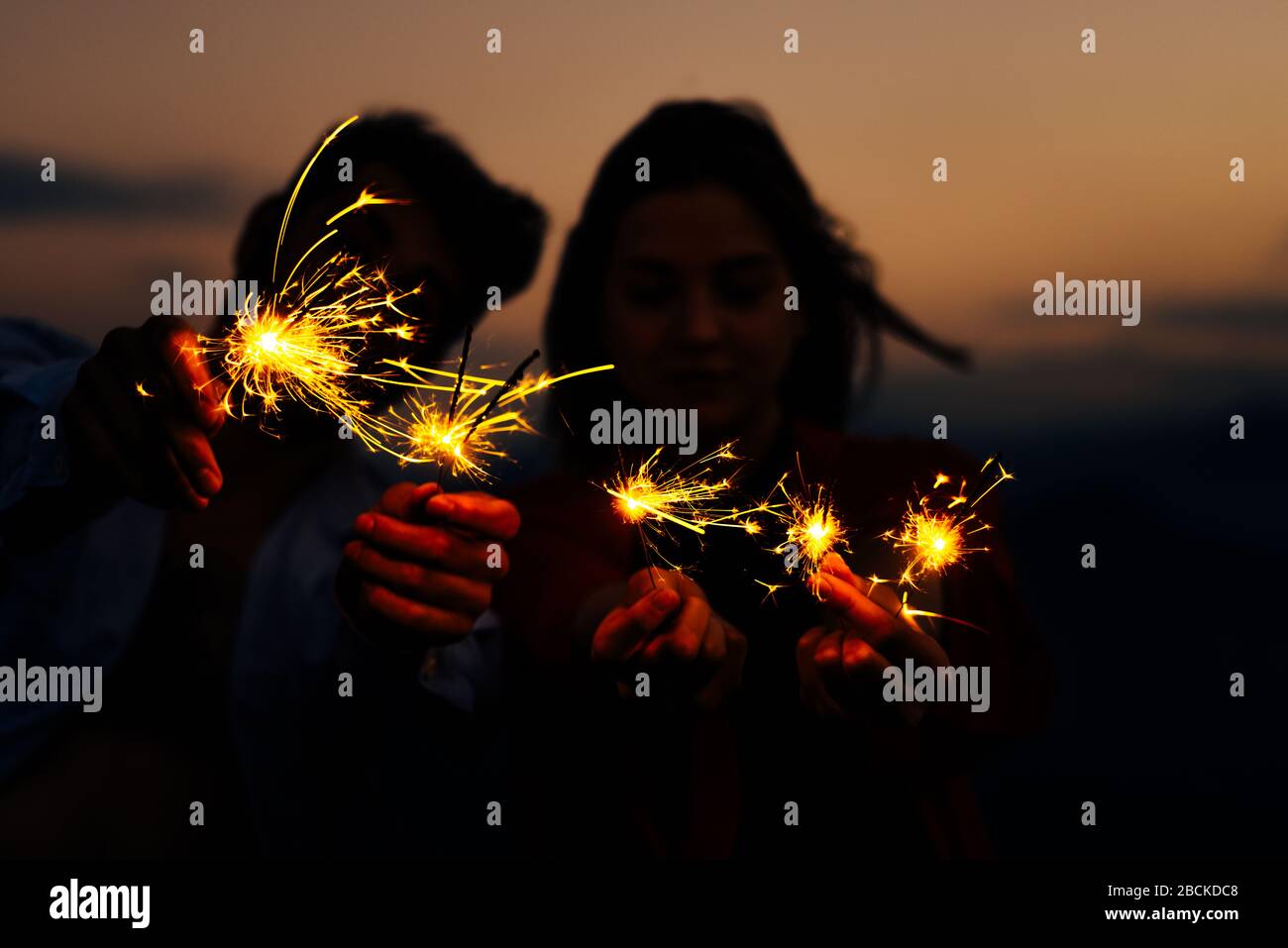 Group celebrating dusk silhouette hi-res stock photography and images ...