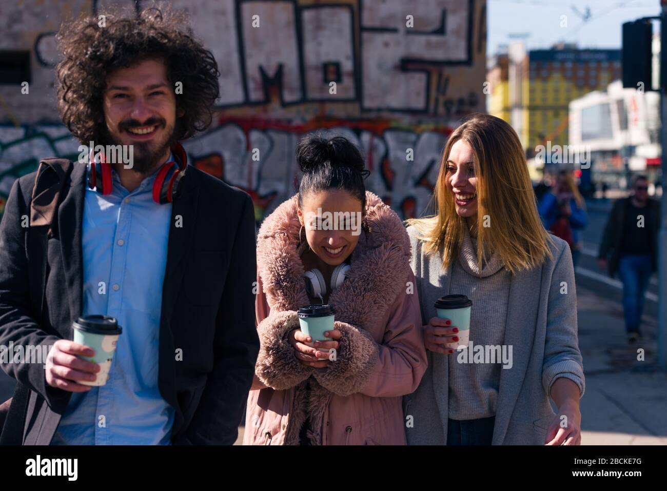 Group of friends (colleagues) hanging out in an urban area Stock Photo ...