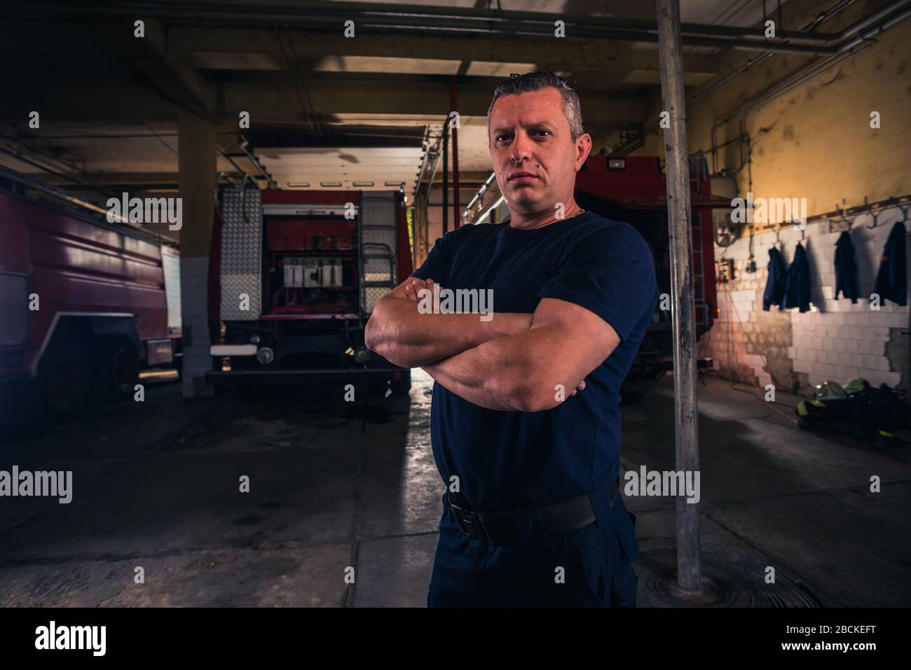 Portrait of fireman standing inside the fire department Stock Photo - Alamy