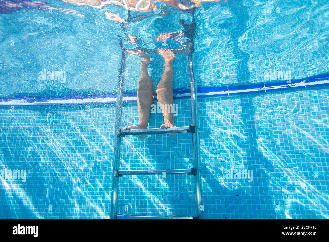 A woman climbs into the pool in Tenerife Stock Photo - Alamy