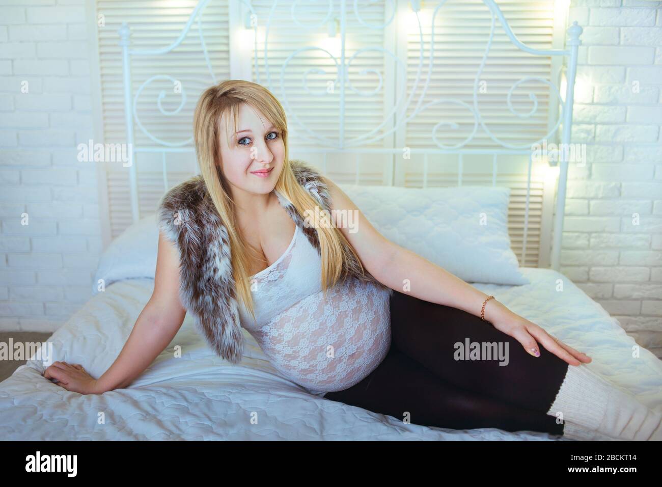 Pregnant girl with a big belly in a studio room Stock Photo - Alamy