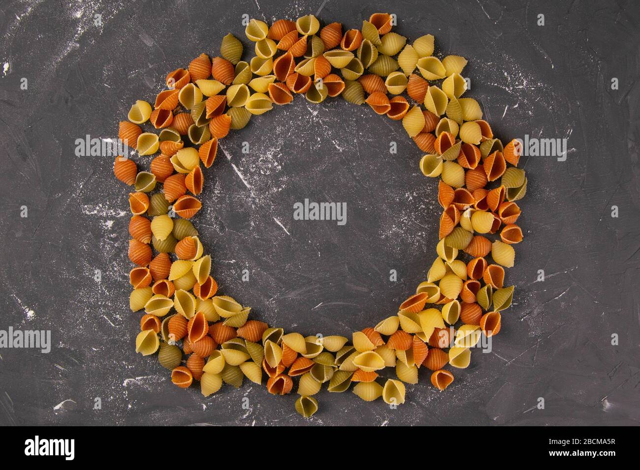 Pasta Conchiglie Rigate, mix of colorful uncooked shells In the shape ...