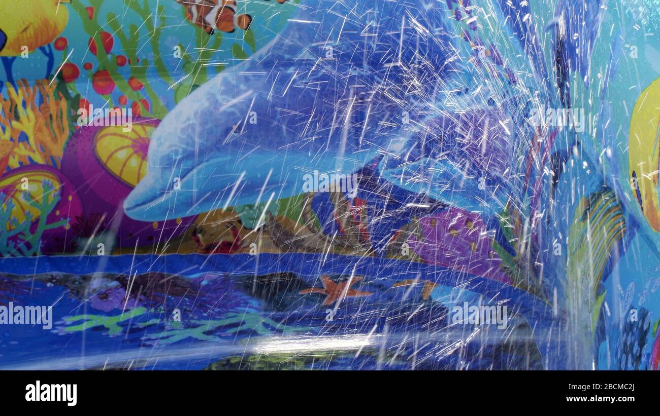 Filling Inflatable pool with water from hose in garden Stock Photo - Alamy